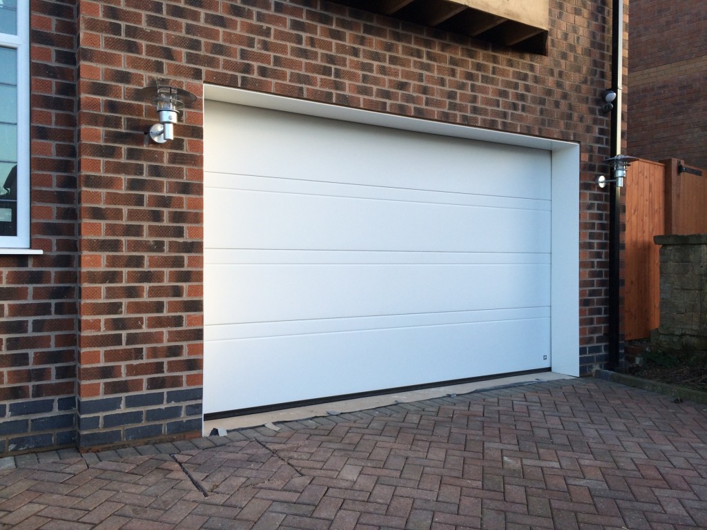 Ryterna Top Rib Slick sectional garage door finished in smooth White.
